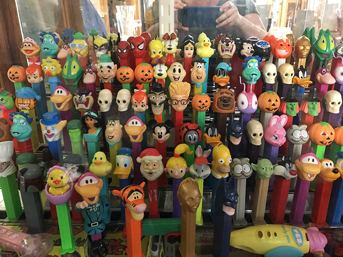 PEZ dispensers standing at attention like a colorful army of pop culture history. Spider-Man to Yoda, they're the sweet-dispensing celebrities of childhood.