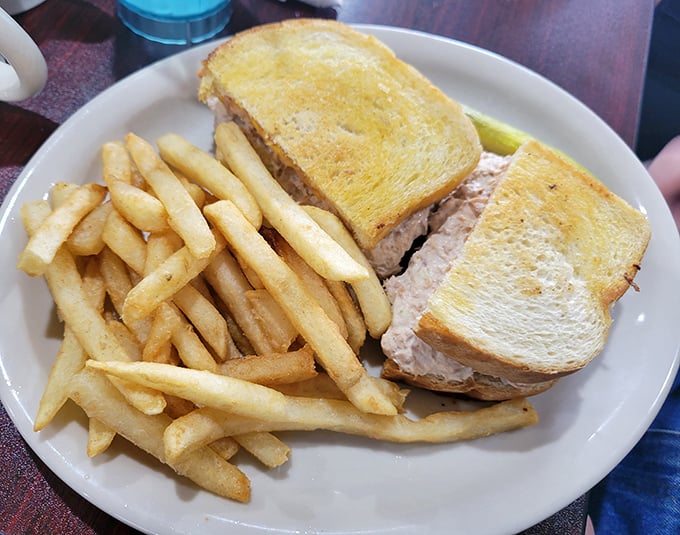 The humble tuna melt, elevated to art form. Golden-toasted bread embracing creamy tuna salad and melted cheese&mdash;comfort food that hugs you from the inside out.