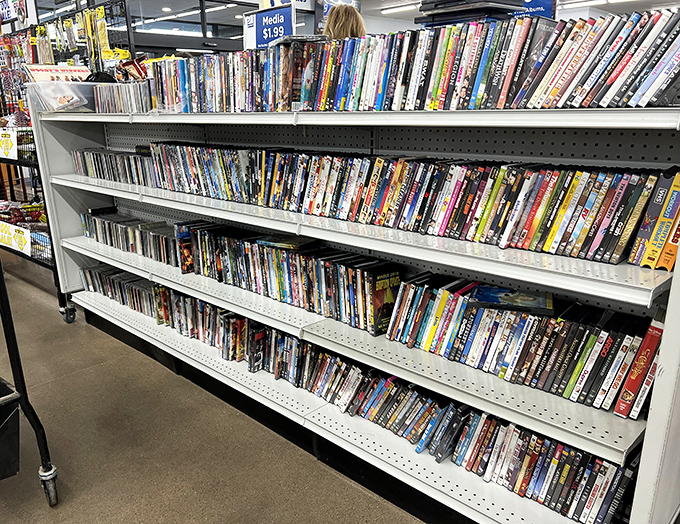 Media shelves packed with cinematic history offer entertainment at pocket-change prices. Remember when we had to rewind before returning? Those were simpler times.
