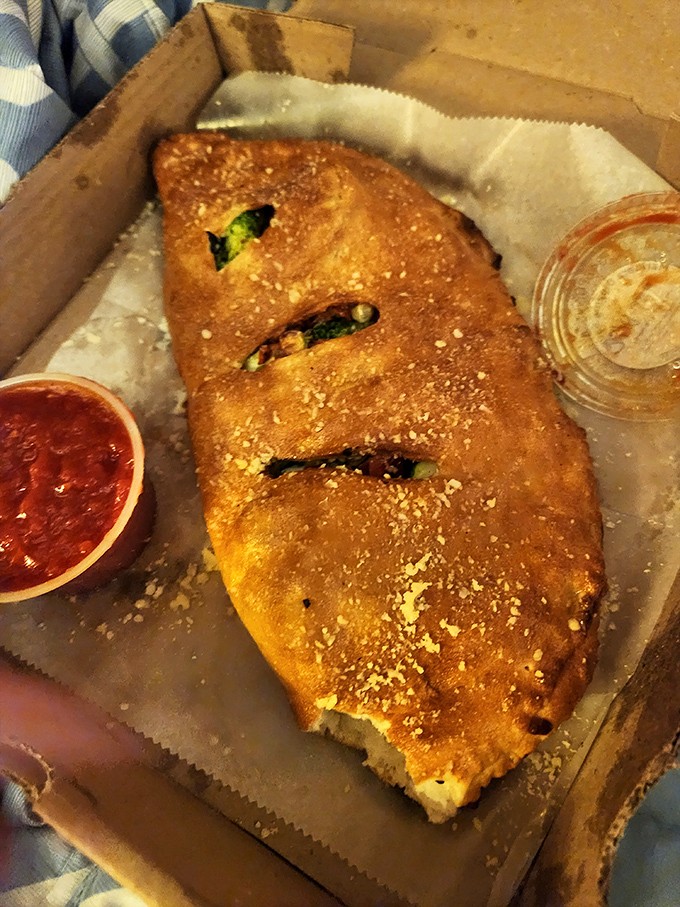 The veggie calzone: proof that vegetables can be just as indulgent as meat when tucked into a golden-brown pocket of joy.