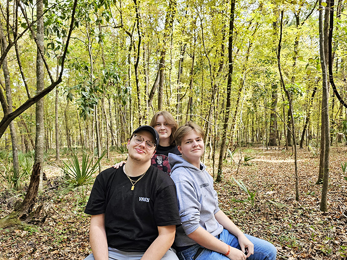 Family memories take root among ancient trees. These visitors found the perfect spot for a photo that says, "Yes, we did something besides Disney!"