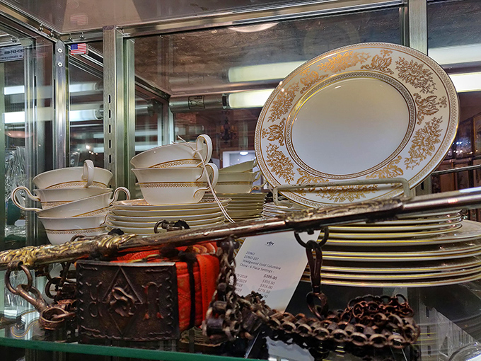 Fine china stacked with precision&mdash;each plate a canvas of gold and cream that makes your everyday dinnerware look like it's trying too hard.