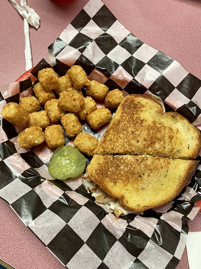 This sandwich and tater tot combo isn't just lunch&mdash;it's edible nostalgia served on a checkered paper that takes you back to simpler times.