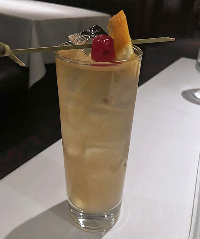 A whiskey sour crafted with the kind of attention usually reserved for neurosurgery or rocket science, garnished with a cherry that means business.