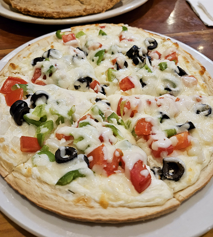 A veggie pizza that proves simplicity reigns supreme &ndash; fresh toppings on a canvas of melted cheese that would make an Italian grandmother nod in approval.