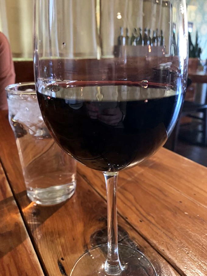 A robust red wine awaits its moment to shine, patiently breathing while plotting to elevate your entire meal.