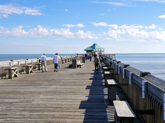 The Folly Beach Pier invites wanderers to venture further from shore, where fishing stories grow taller with every step.