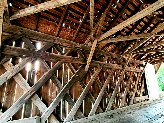 Sunlight filters through the wooden truss system, creating a cathedral-like atmosphere that transforms a simple crossing into a transcendent experience.