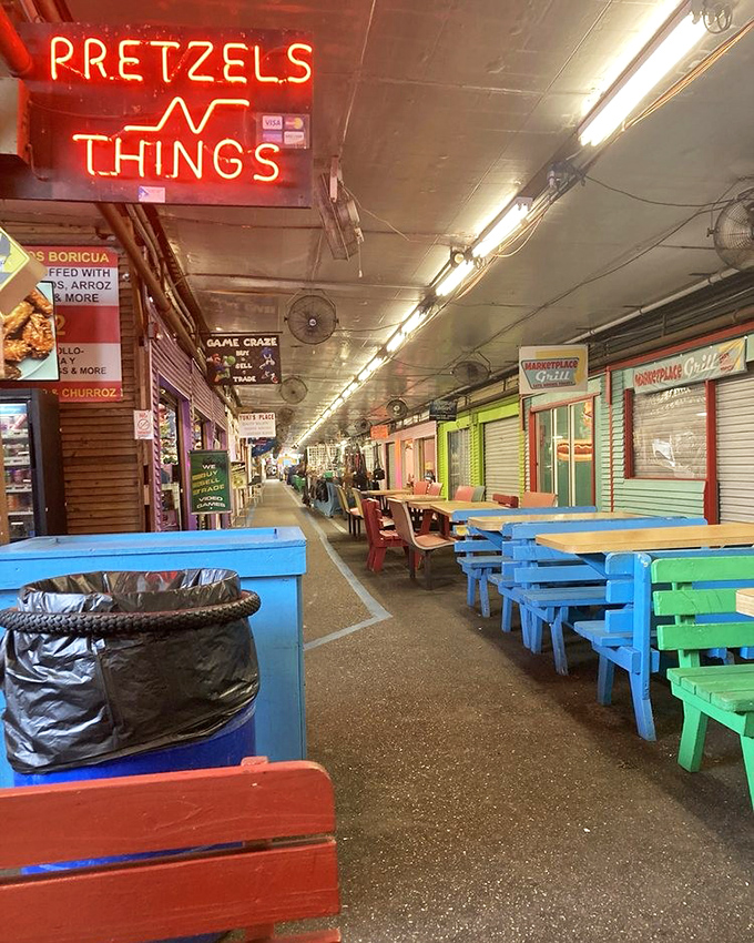 "Pretzels N Things" beckons hungry shoppers with its neon glow, while colorful picnic tables invite you to rest weary feet.