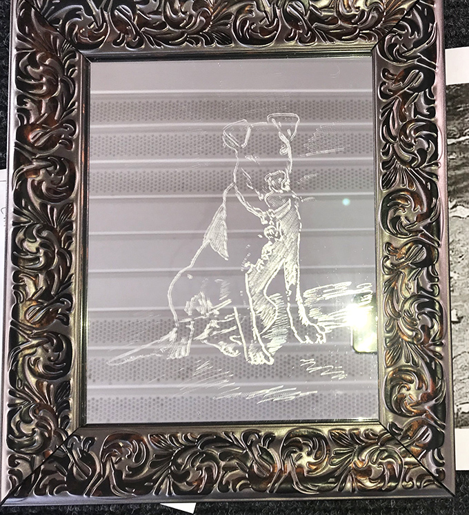 Art with heart! This etched glass dog portrait in an ornate frame proves one shopper's castoff becomes another's conversation piece.