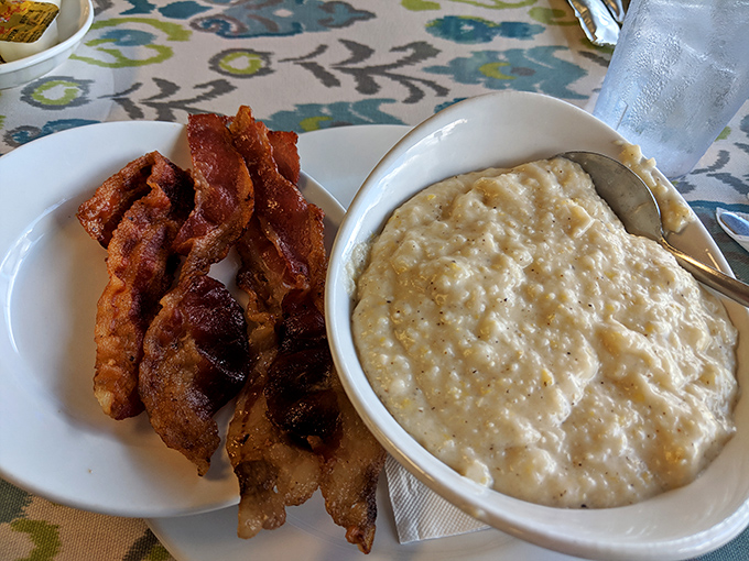 Bacon strips and creamy grits &ndash; proof that sometimes the simplest pleasures are the most profound ones.