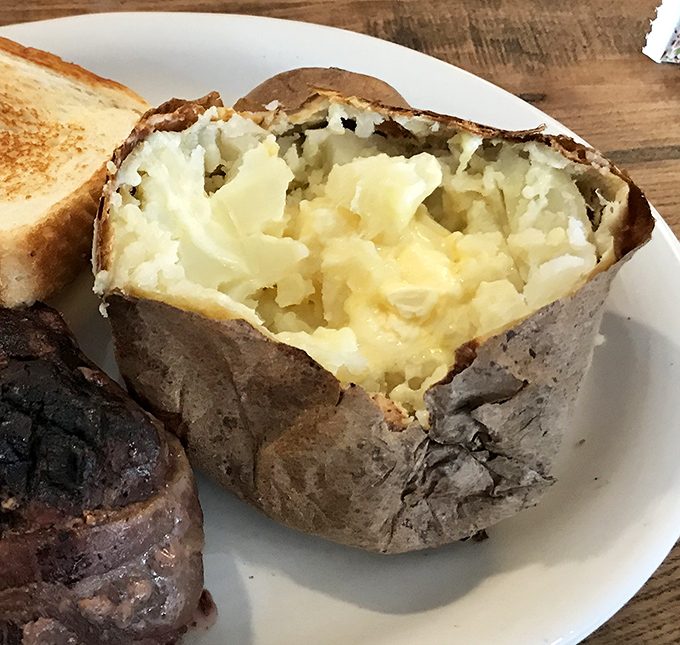 Behold the humble baked potato in all its glory &ndash; a fluffy interior waiting patiently for your butter and sour cream artistic expression.