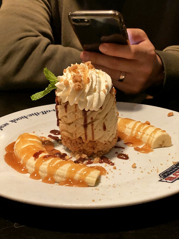 A towering banana pudding that demands your phone's attention before your spoon's. Caramel drizzles add that "I'm dressed for the occasion" touch.