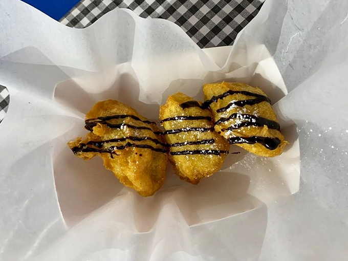 These banana fritters drizzled with chocolate sauce are what would happen if a carnival and a five-star restaurant had a delicious baby.