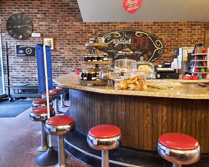 The counter where regulars become family. That "Crystal Cafe: TO DIE FOR" sign isn't hyperbole&mdash;it's a warning your diet plans might need rescheduling.