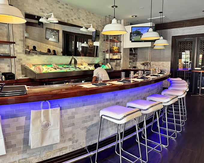 The raw bar&mdash;where seafood aficionados gather like pilgrims at a shrine. That blue lighting isn't just ambiance; it's setting the mood for a serious relationship with shellfish.