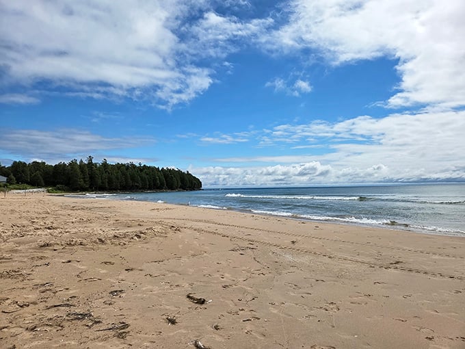 Sand as far as the eye can see. This expansive shoreline offers enough space for contemplative walks without stepping on anyone's beach towel.