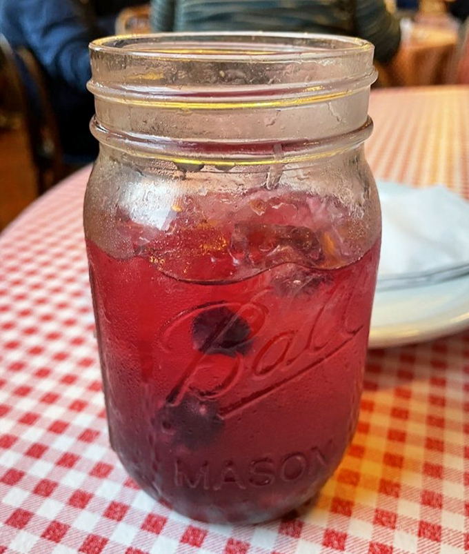 That ruby-red drink in a Mason jar isn't just refreshing&mdash;it's a liquid reminder that sometimes the simplest pleasures deserve the prettiest presentation.