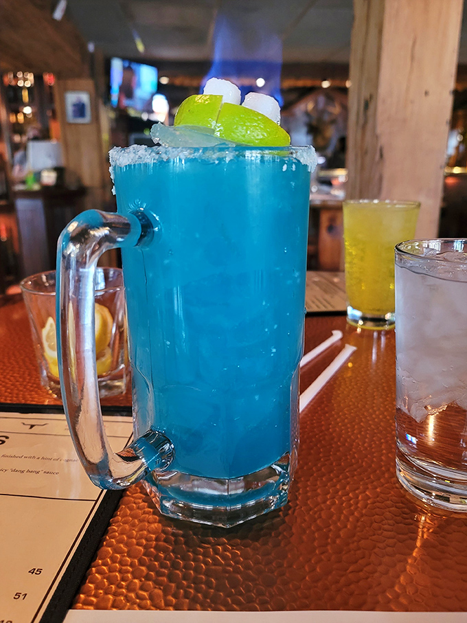 The Blue Lagoon cocktail&mdash;because sometimes your steak deserves a tropical vacation companion. Those lime wedges and marshmallows are having more fun than most people on spring break.