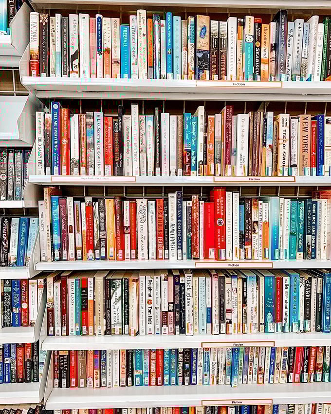 The fiction section stands as a paper time machine, each spine a portal to worlds unknown and adventures untaken.