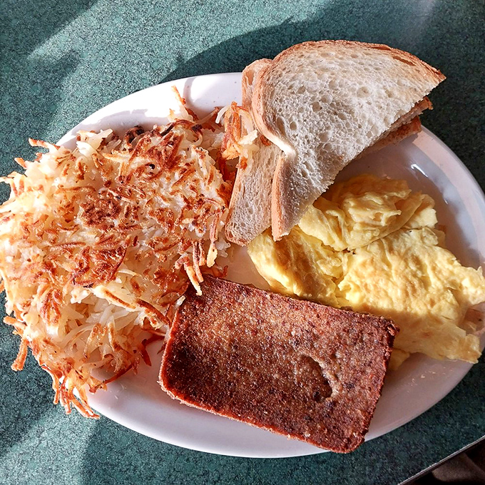 The breakfast trinity: perfectly scrambled eggs, crispy hash browns, and what appears to be scrapple&mdash;the holy grail of Pennsylvania breakfast meats.