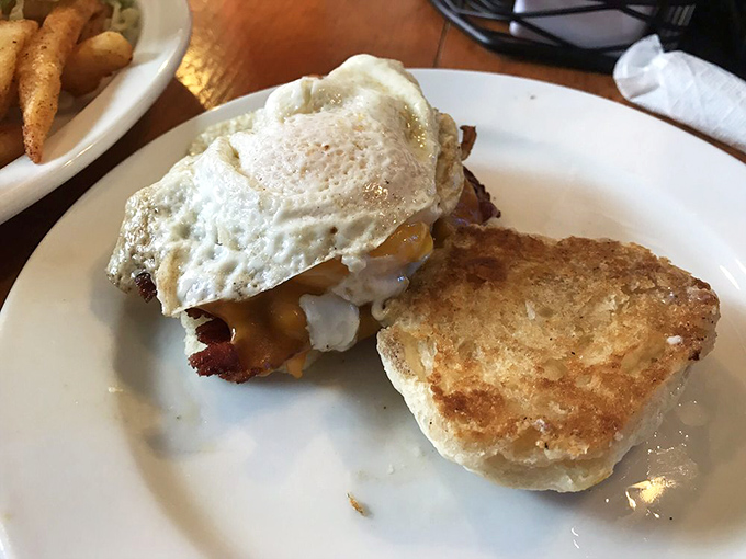 Breakfast sandwich architecture at its finest&mdash;where the sunny-side egg becomes both structural element and sauce in one brilliant move.