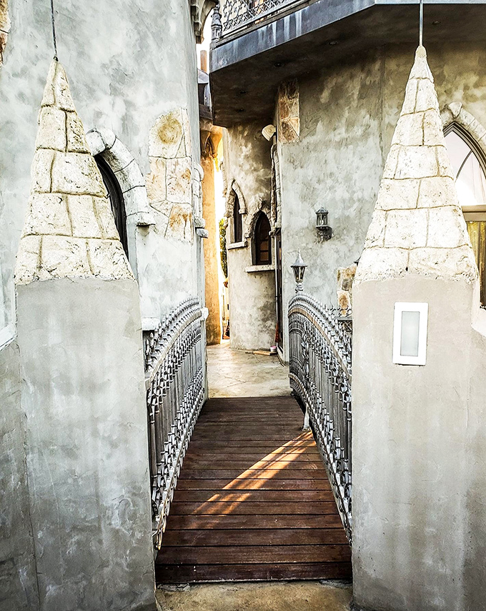 This wooden bridge beckons adventurers into the castle's inner sanctum. Each step across feels like crossing from our world into a storybook realm.
