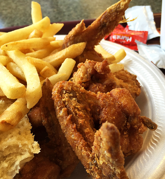 The holy trinity of comfort food: crispy chicken, golden fries, and a biscuit that doesn't need Instagram filters to look absolutely irresistible.