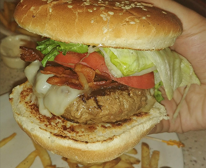 This isn't just a burger&mdash;it's a hand-held masterpiece of melted cheese, crispy bacon, and fresh veggies that demands to be photographed before the first bite.