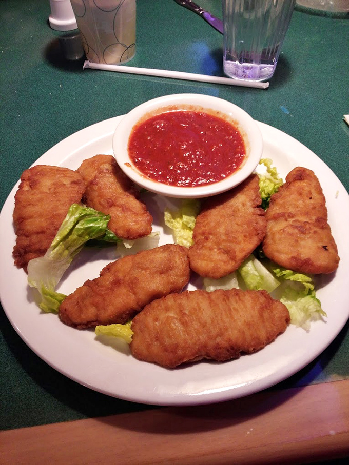 Golden-fried chicken tenders that crunch louder than your diet plan breaking, served with marinara that brightens each bite.