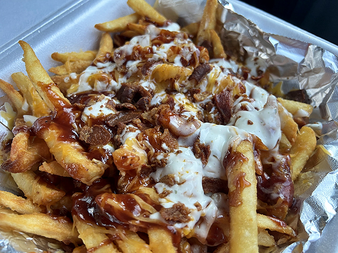 These loaded fries aren't just a side dish &ndash; they're a main event. Cheese, bacon, and sauce creating a symphony of indulgence.