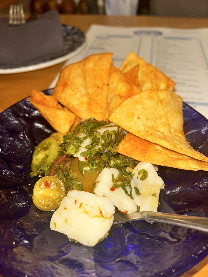 These aren't just scallops; they're buttery treasures from the sea, perfectly seared and topped with a confetti of fresh vegetables.