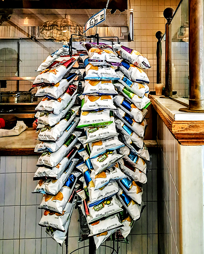 The mountain of chip bags isn't decoration&mdash;it's a testament to the volume of hungry customers who make the pilgrimage to this sandwich sanctuary.