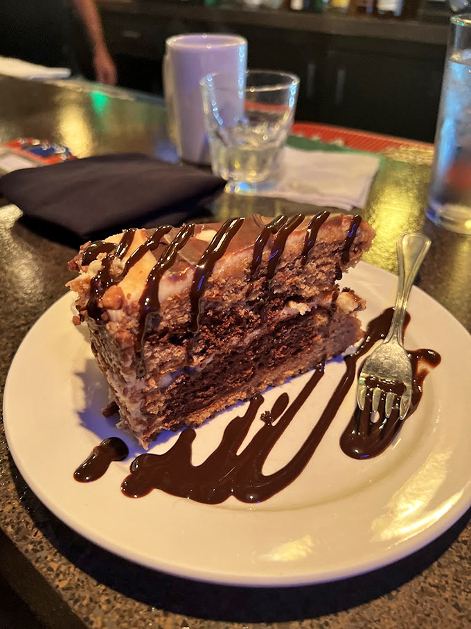 A slice of chocolate cake so decadent it should require a permission slip. That chocolate drizzle isn't decoration—it's an exclamation point.