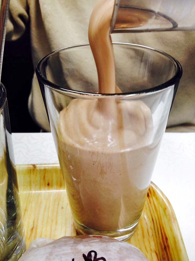 The chocolate milkshake&mdash;thick enough to require serious straw strength. This isn't a drink; it's a dessert that happens to be sippable... eventually.