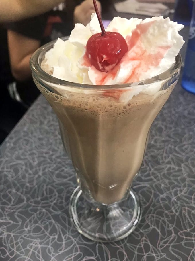 A milkshake so thick and creamy it demands both a straw and a spoon. The cherry on top isn't just garnish&mdash;it's a promise.