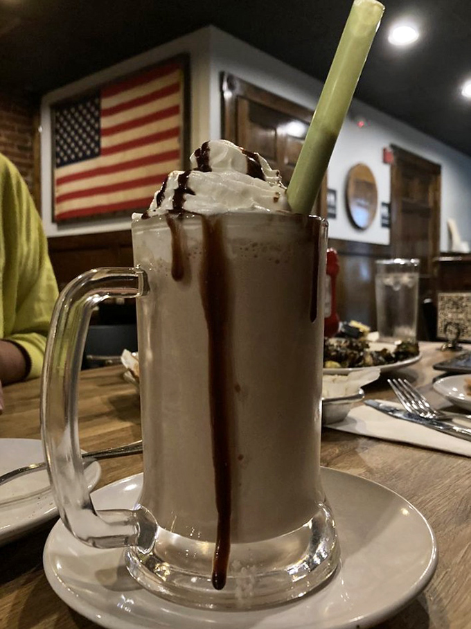 A chocolate shake so thick it defies gravity and common sense. The straw stands at attention, as if saluting its own delicious destiny.
