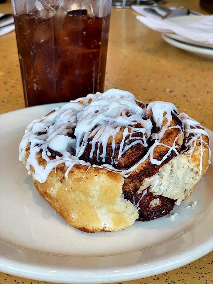 This cinnamon roll isn't just dessert, it's a spiral-shaped argument for why calories don't count when something tastes this heavenly.