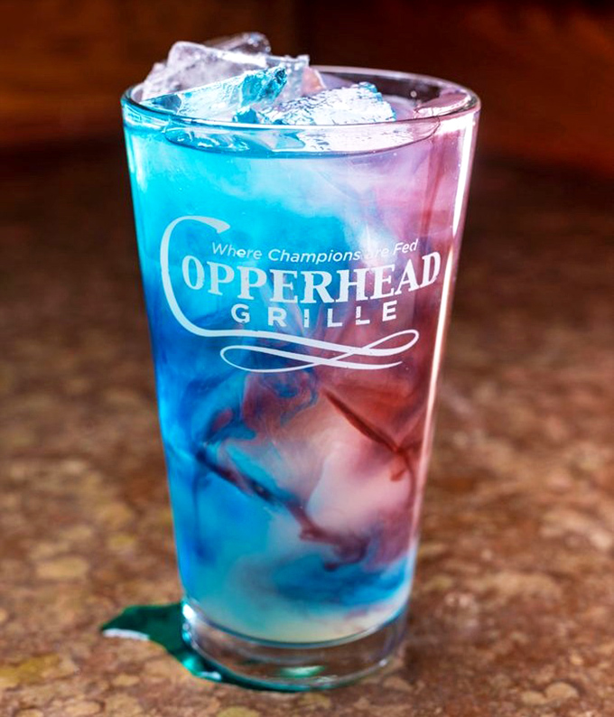 A cocktail that's having more fun than most people. Those blue and red layers aren't just pretty&mdash;they're plotting flavor revolution.