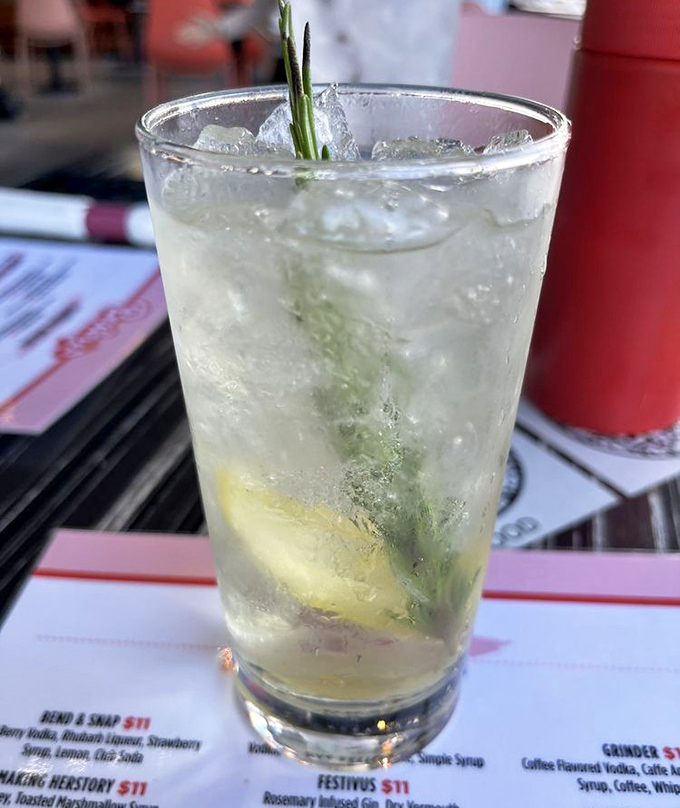 A cocktail that looks deceptively simple but, like a good conversation, reveals surprising depth with each sip &ndash; note that sprig of rosemary standing guard.