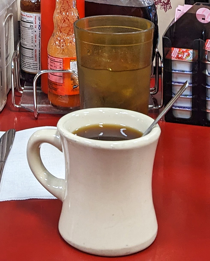That sturdy white mug doesn't just hold coffee&mdash;it cradles liquid motivation in a vessel that's survived decades of morning conversations.