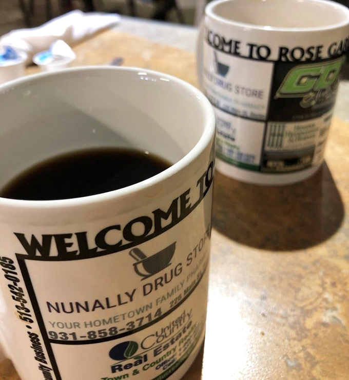 Coffee mugs advertising local businesses - the hallmark of a true community restaurant where everyone knows your regular order.