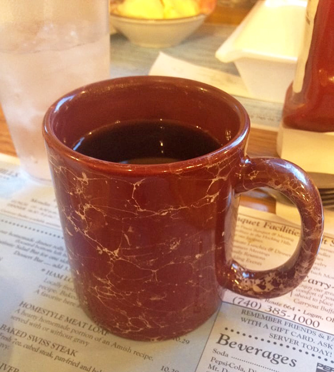 That classic diner coffee mug – sturdy, no-nonsense, and filled with the liquid courage needed to tackle the buffet for round two.