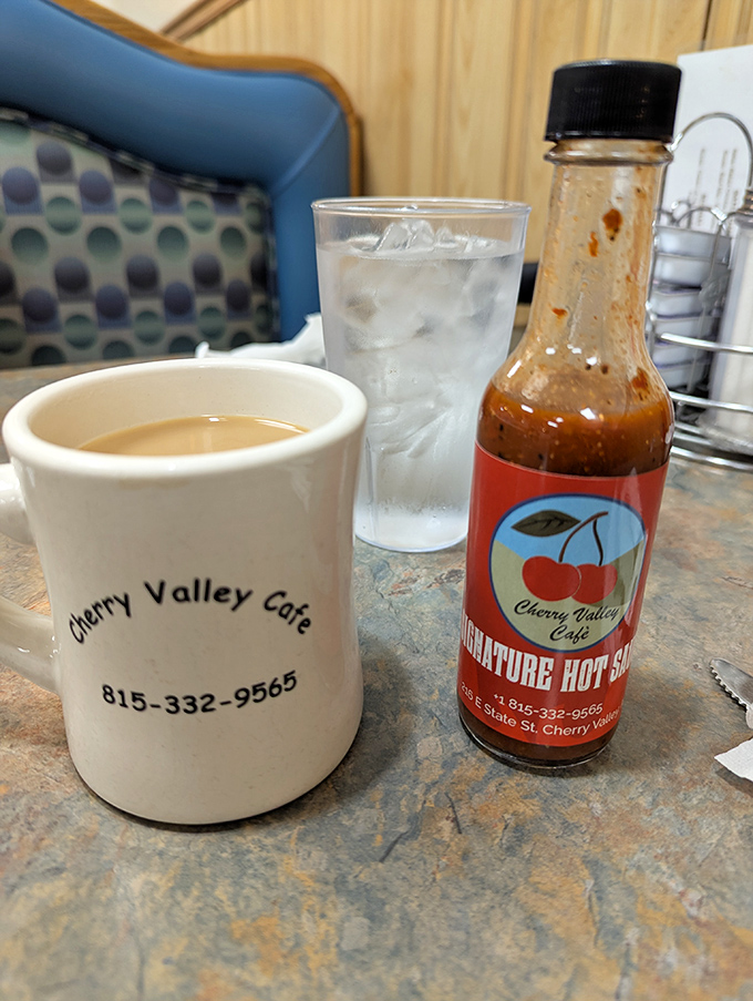 The holy trinity of diner happiness: strong coffee in a sturdy mug, ice water, and house-made hot sauce that means business.