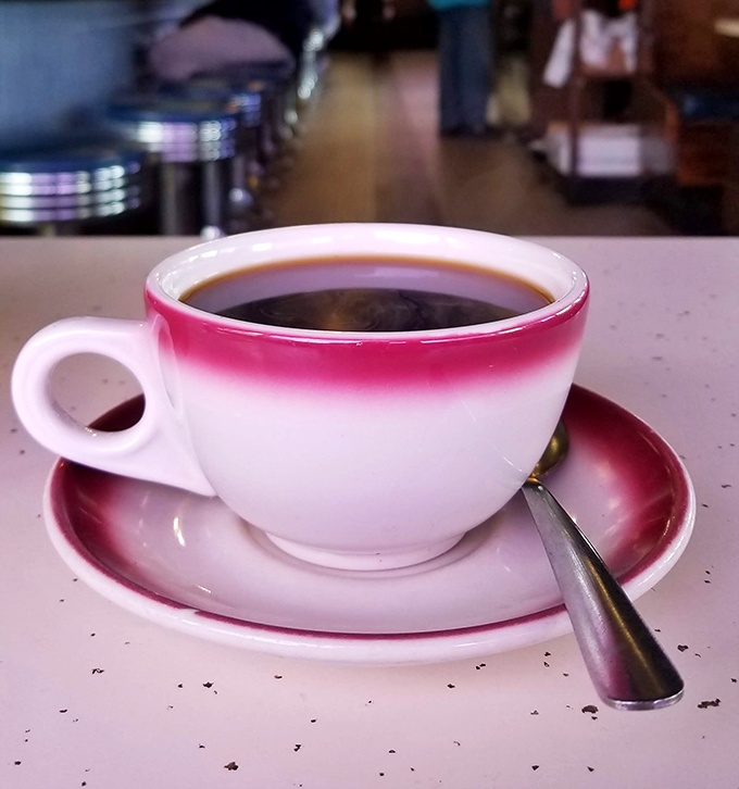 That pink-rimmed cup isn't just holding coffee; it's holding the fuel that's powered Maryland mornings since before your parents were dating. 