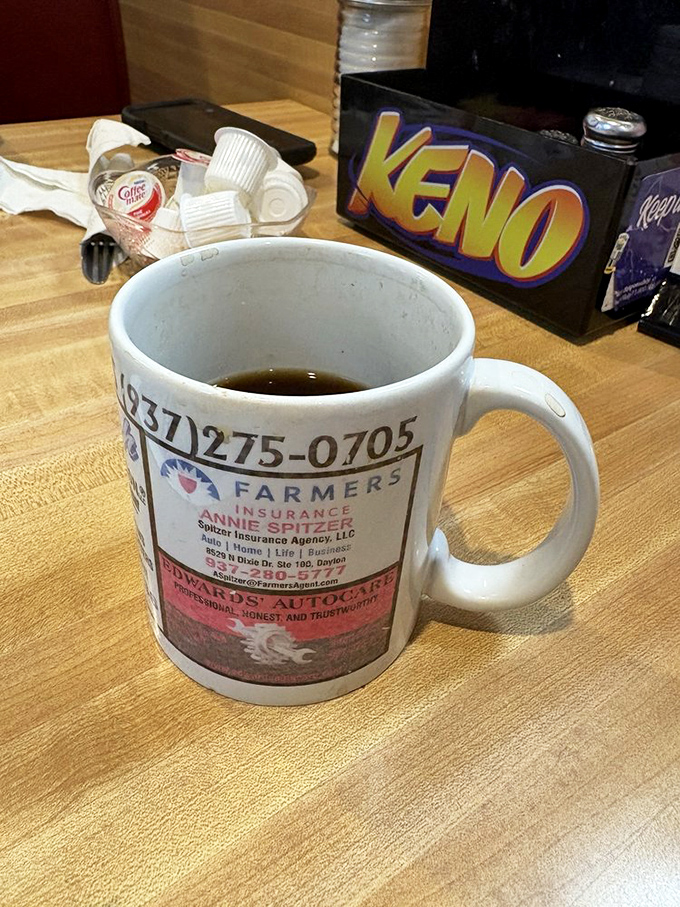 Even the coffee mugs tell stories here, advertising local businesses while delivering the caffeine necessary for meaningful conversation.