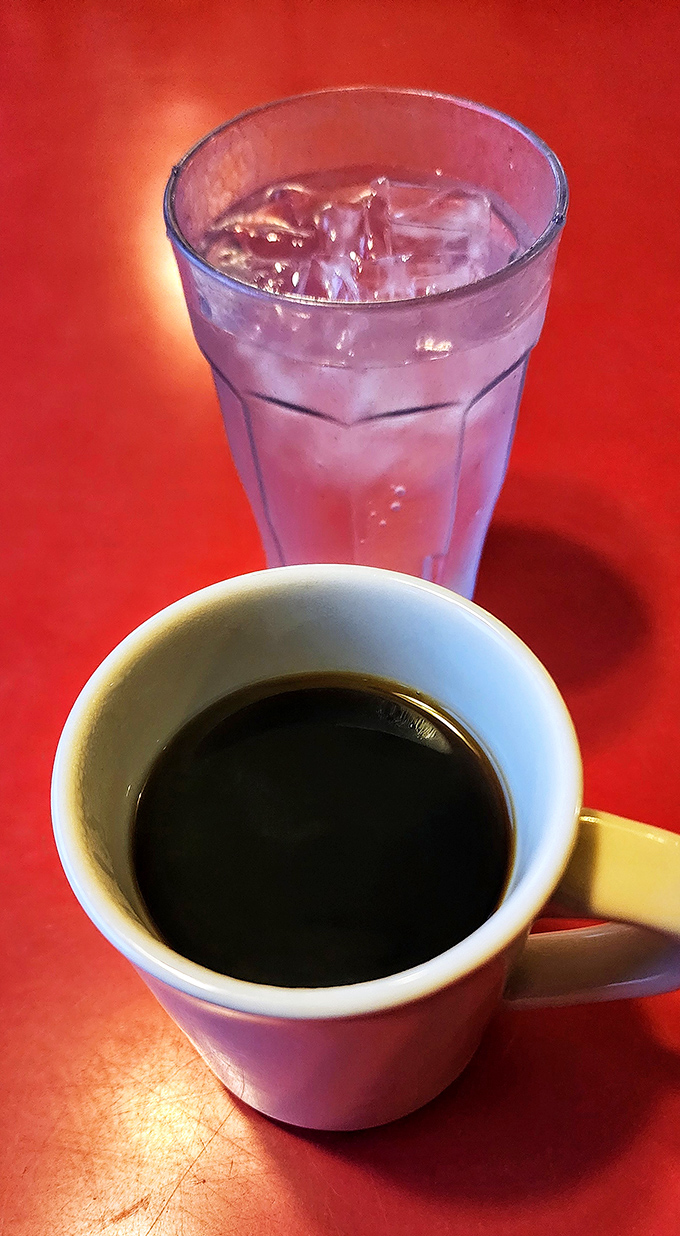 The perfect diner duo: coffee black as midnight alongside water clear as day. Simple pleasures that bookend every great diner experience.