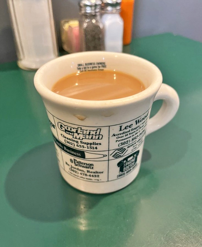 The coffee cup &ndash; adorned with local business ads &ndash; promises refills and conversation in equal measure.