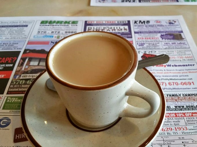 Coffee in a proper diner mug, resting on yesterday's news&mdash;a morning ritual as American as the pancakes it accompanies.