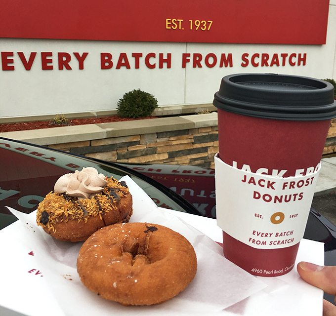 Coffee and donuts against the "EVERY BATCH FROM SCRATCH" promise&mdash;a morning ritual that feels like joining a delicious secret society.